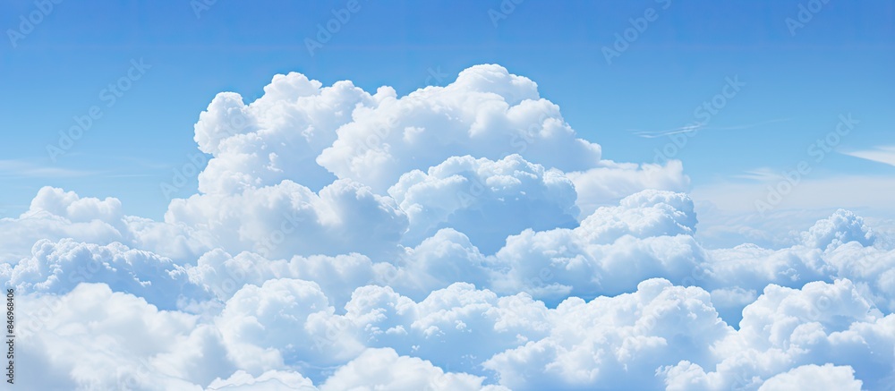 Large cloud positioned above layers of white clouds against a blue sky. with copy space image ...
