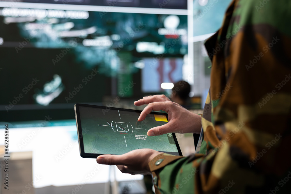 Military IT engineer collecting intelligence from world map projection ...