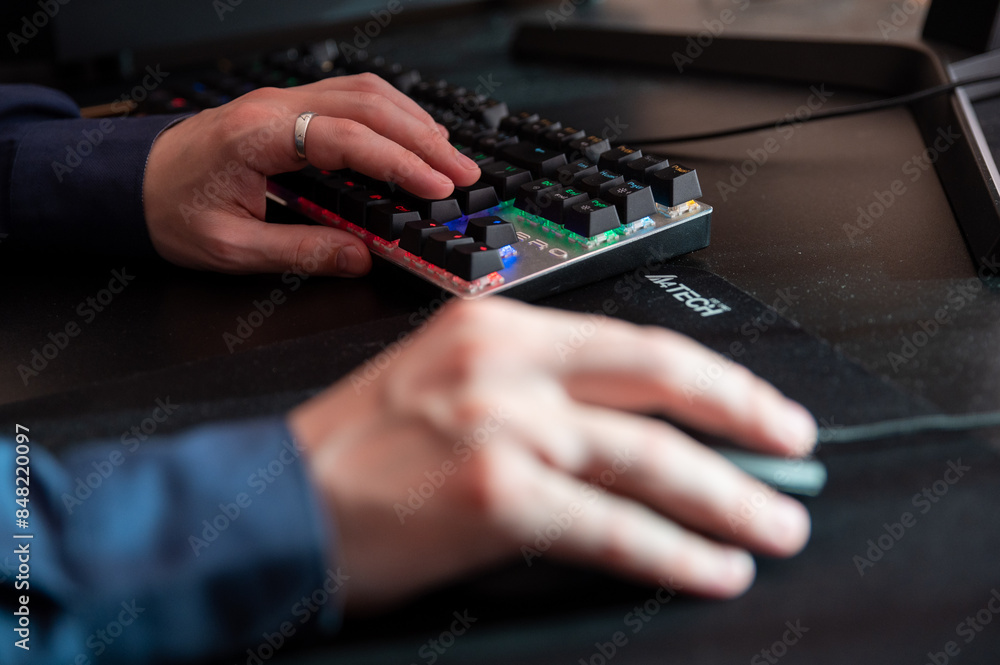 Focus on Hands, Keyboards and Mouse. Back view of young gamer playing ...