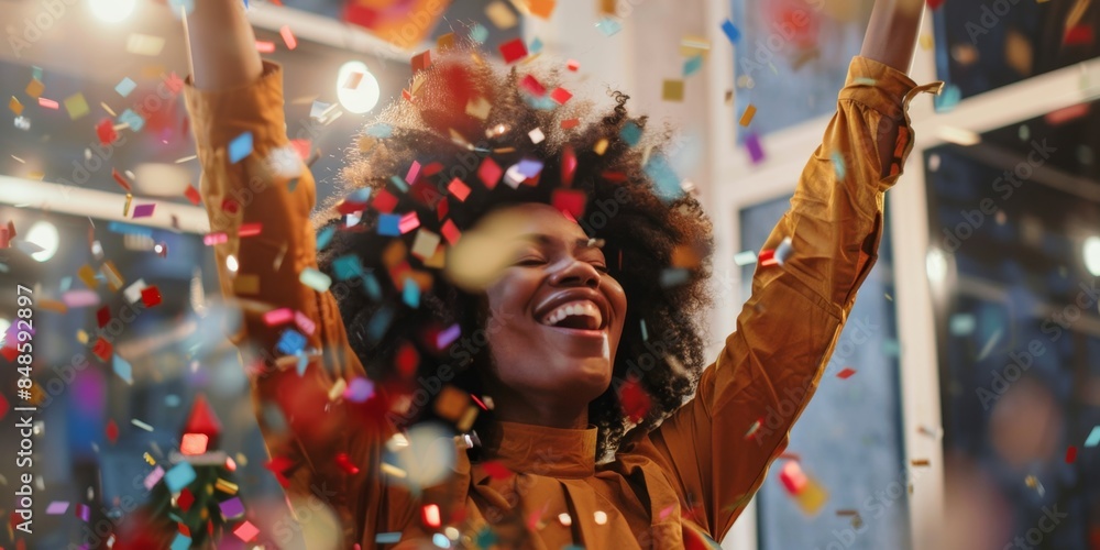 Happy black woman dancing under confetti at office Christmas party ...