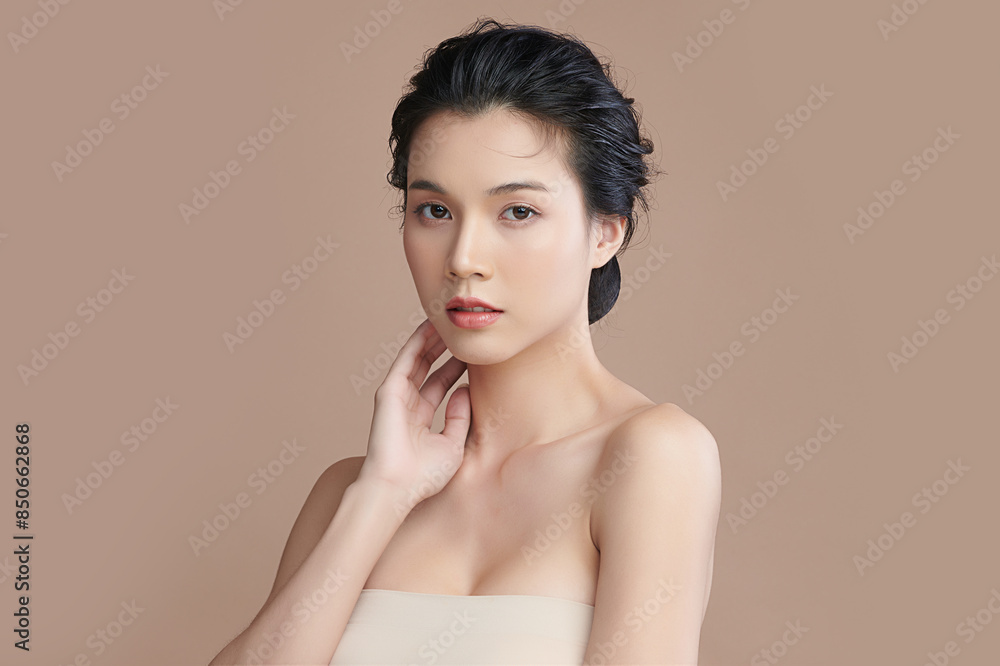 Beautiful young asian woman with clean fresh skin on beige background ...