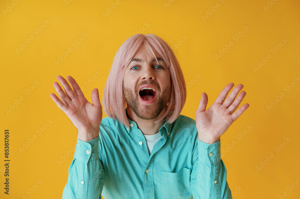 Making facial expression, hand gestures. Guy with pink hair is posing ...