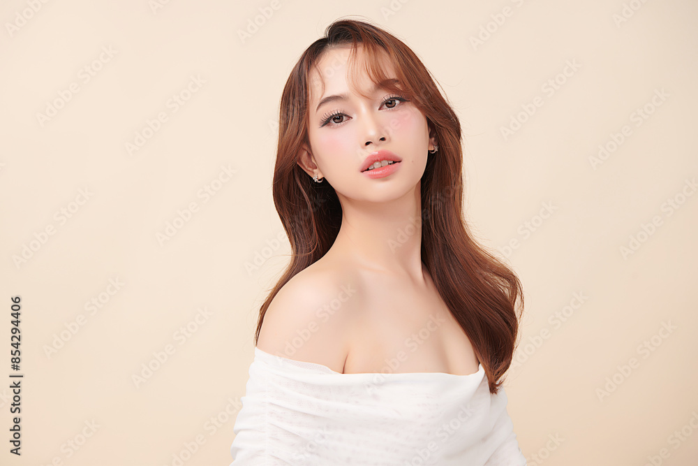 Beautiful young asian woman with clean fresh skin on beige background ...