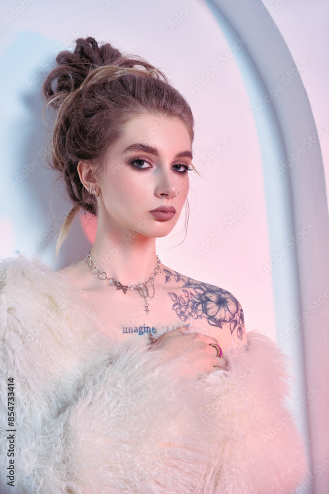 Woman wearing a white fur coat and sporting a messy bun poses for a ...