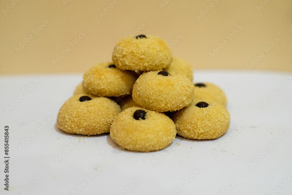 Kue Janda Genit or Monde Susu Cookies with chocolate chips on top with ...