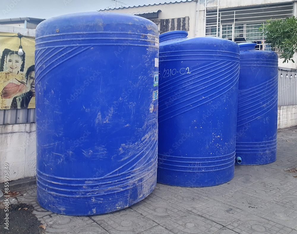 BANGKOK, THAILAND - JUNE 25, 2024: Rows of large blue plastic water ...