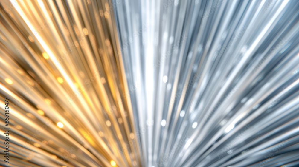 Abstract image of gold and silver light beams radiating outwards ...