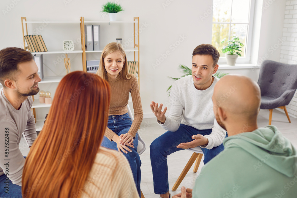 People in group therapy having an interesting discussion. Happy male ...