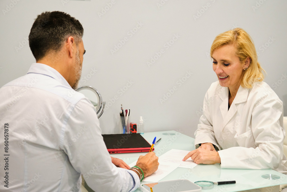 Patient man signing up the consent form in a esthetic clinic. Aesthetic ...