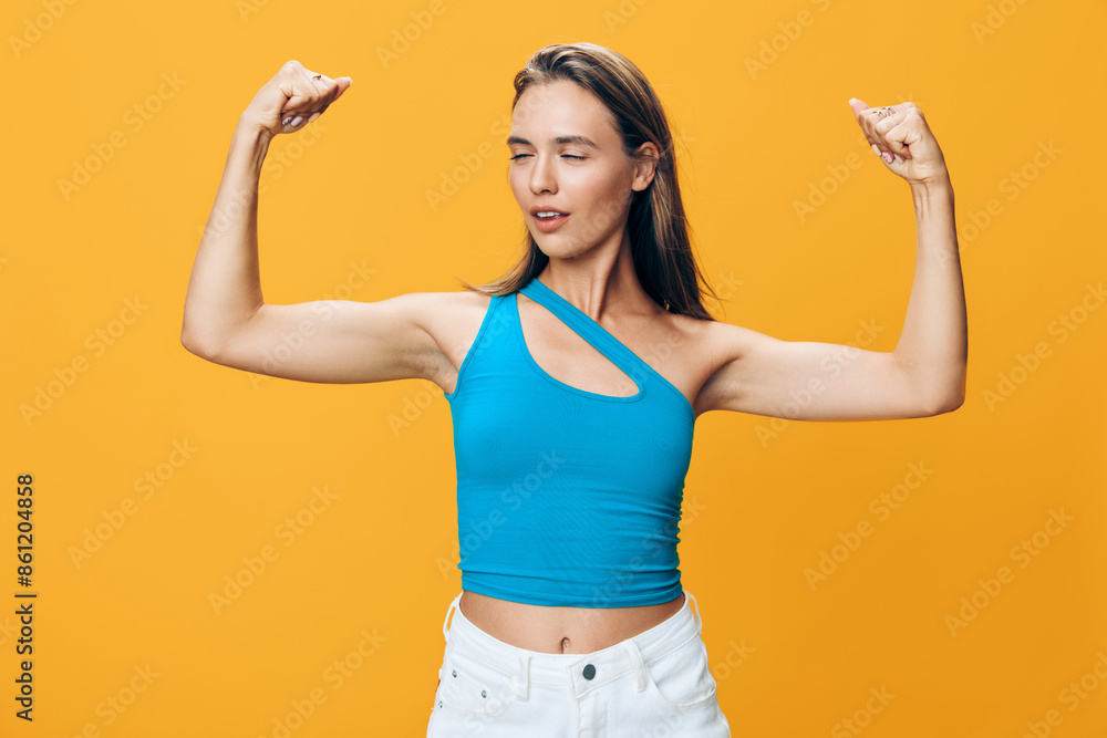 Empowered young woman showing strength and confidence as she flexes her ...