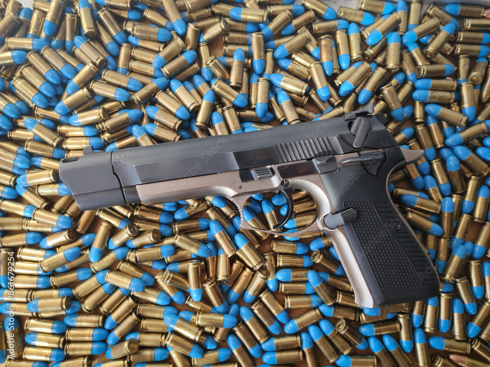 Powerful 9mm pistol with muzzle brake on top of a bed of blue tipped ...