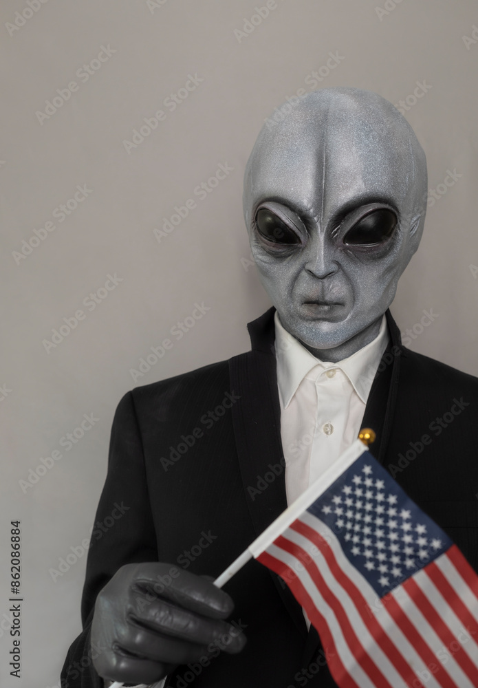 Extra Terrestrial Being, Portrait Of Alien Wearing Suit And Holding ...