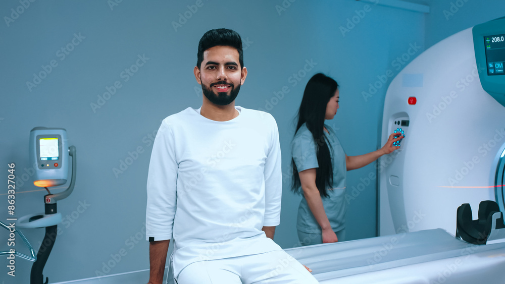 Muslim patient undergoing magnetic resonance tomography. Cheerful ...