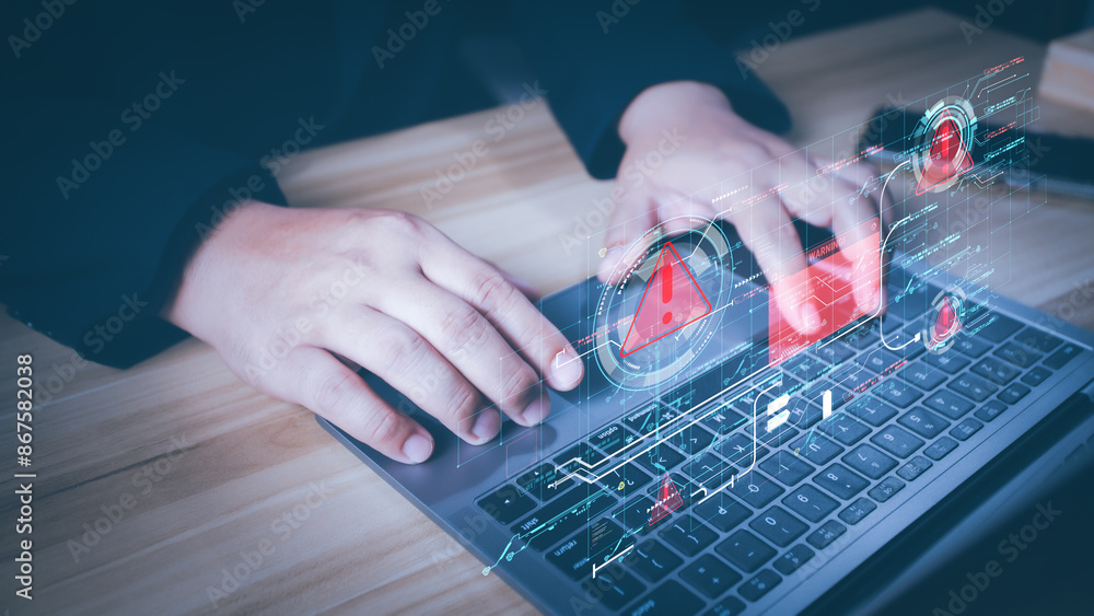 Hacker or programmer using laptop with triangle caution warning sign, coding, cryptography ...