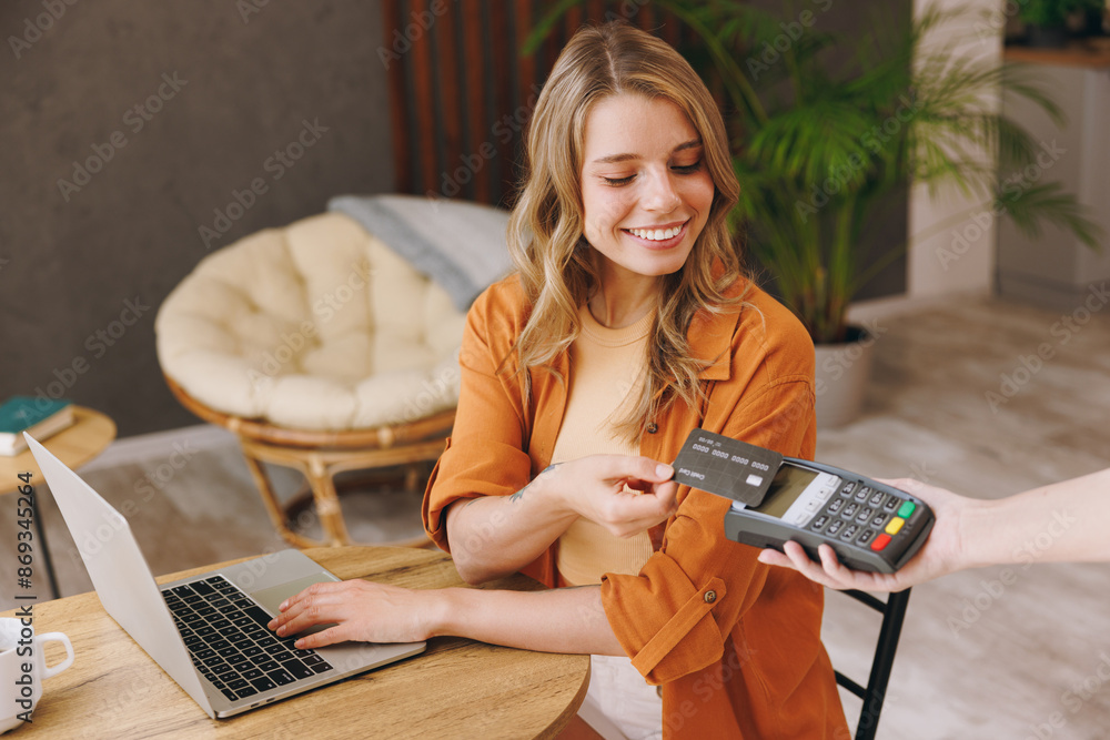 Young woman wear shirt holding bank payment terminal to process acquire ...