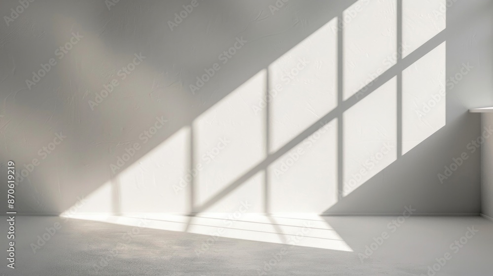 A subtle interplay of light and shadow on a white wall, with an angled shadow from a forgotten ...
