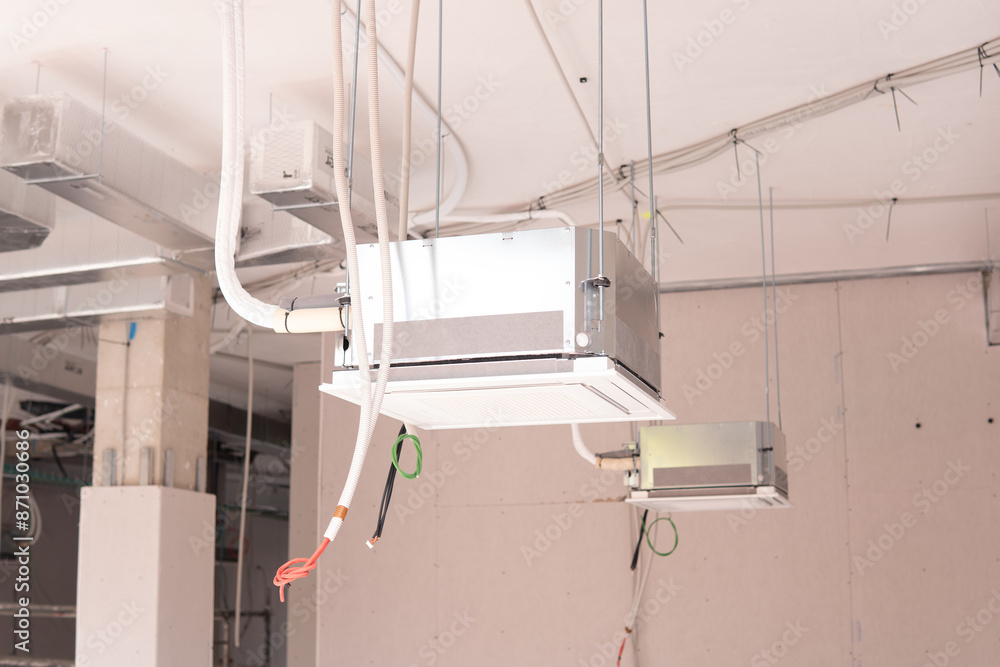 installation of industrial air conditioner hanging from the ceiling in ...