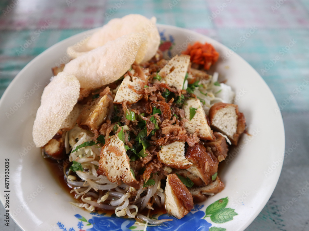 Indonesian food called "Tahu Guling". Contains sliced cabbage, slices ...
