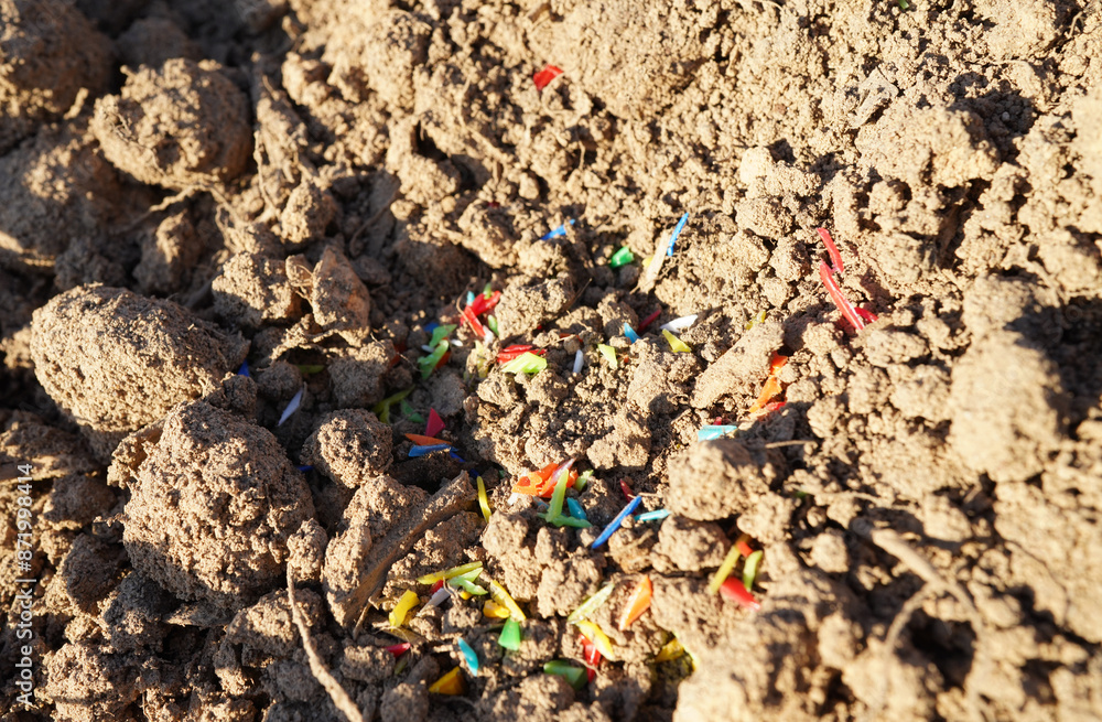 Microplastic pollution. Microplastics in ground. Soil contaminated with ...