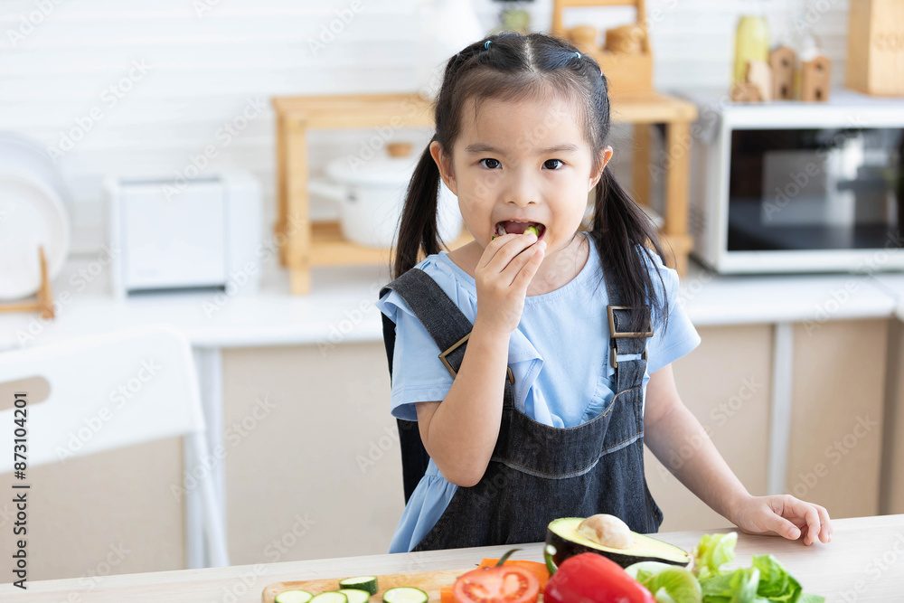 cute asian little child girl eating slice a cucumber with different ...