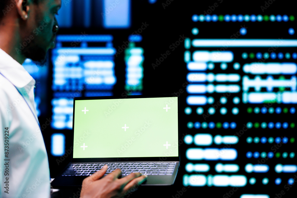 Developer examining server rigs performance trends using chroma key device. Expert using green ...