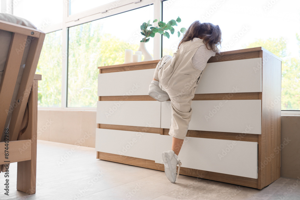 Cute little girl climbing up on high commode at home, back view. Child ...