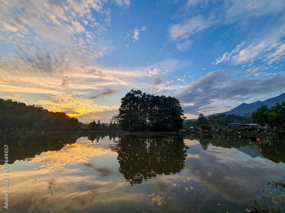 Beautiful sunrise with sky reflection of situ Wanayasa. One of spot ...