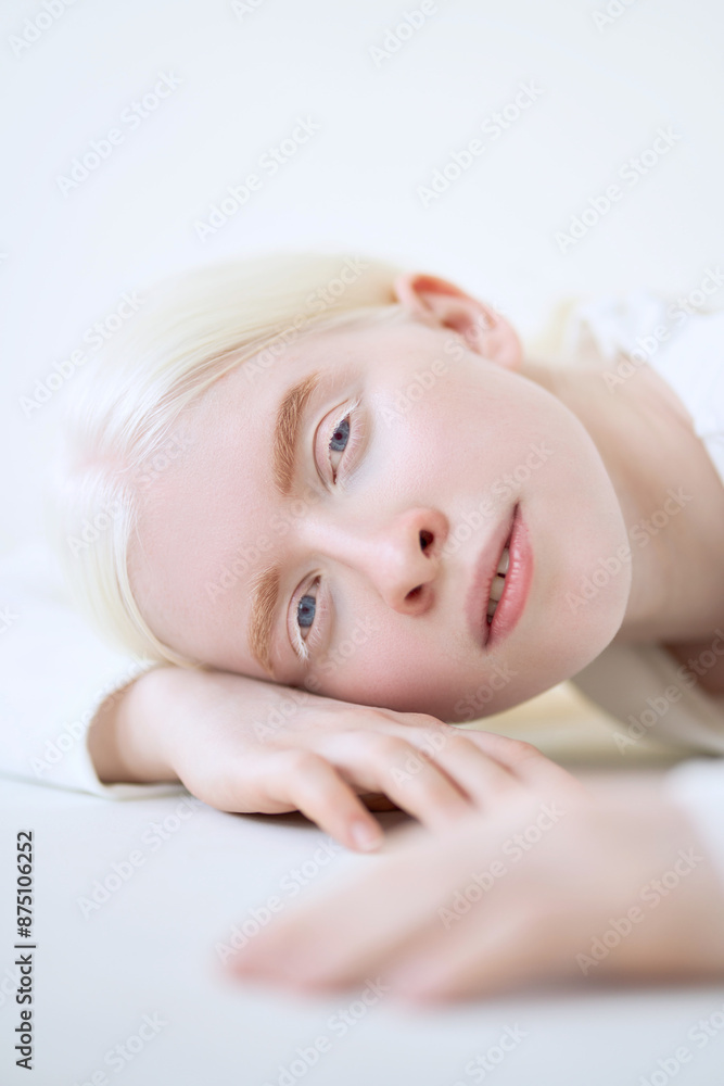 Pretty albino teen girl, beautiful unique woman model in white lying on ...