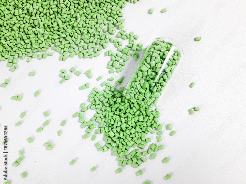 Matcha green masterbatch granules with glass tube on white background ...