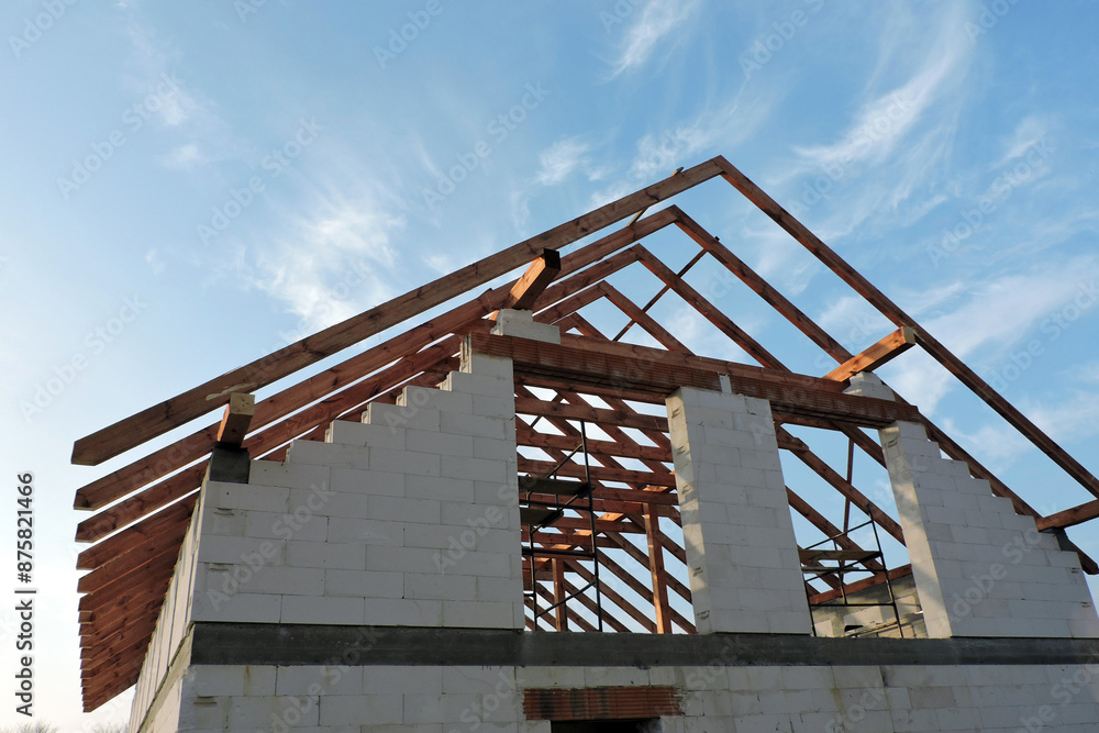 An "A" frame timber roof truss in a house under construction seen from ...
