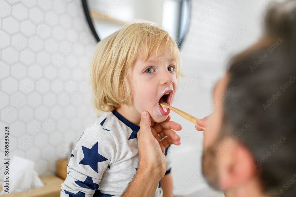 Father brushing son's teeth. Morning routine for young boy before going ...