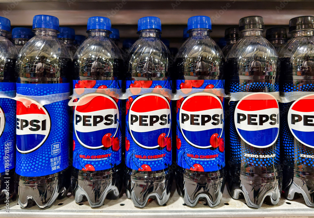 Pepsi, Cherry Flavored, and Zero sugar Pepsi bottles neatly arranged on ...