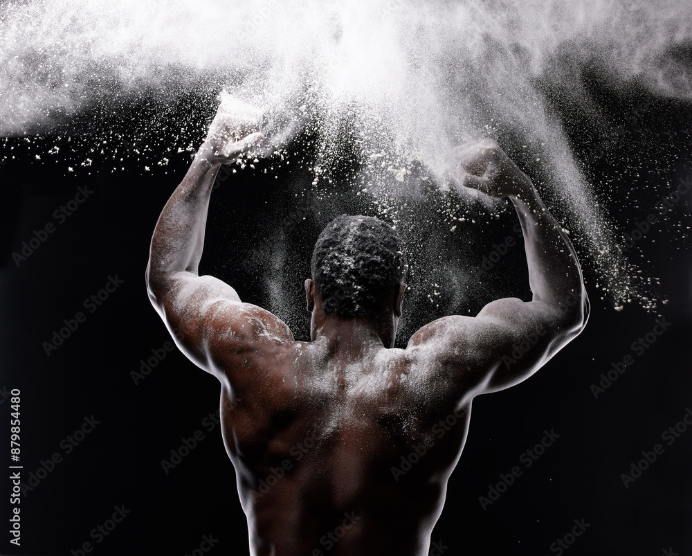 Back, black man and shirtless with powder in studio on dark background ...