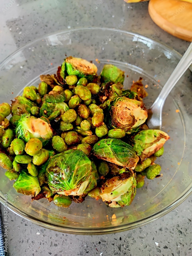 Fried Brussels Sprouts and Edamame Salad with Soy Sauce in Glass Bowl の ...