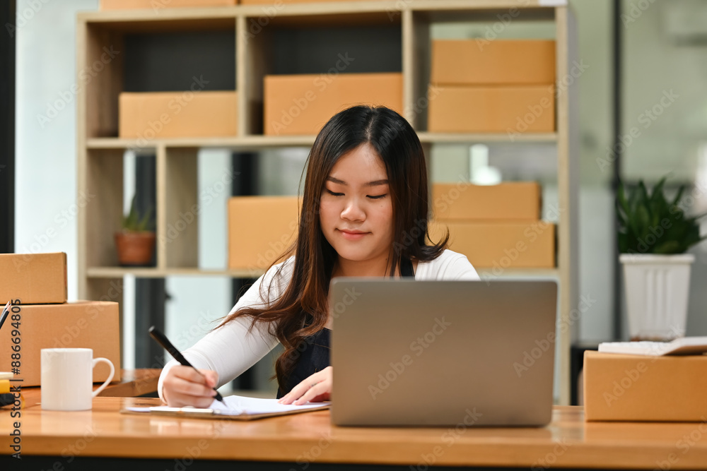 Business owner planning strategies for her startup, surrounded by ...
