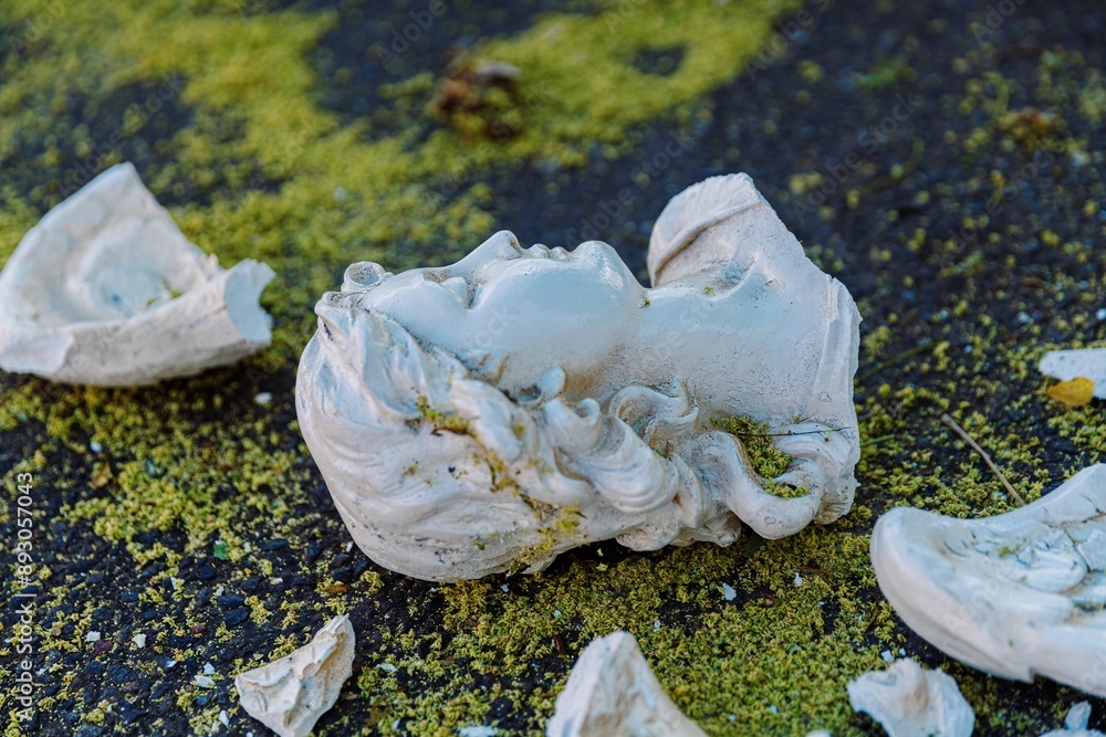 Broken bust of an angel statue smashed on the ashphat. Old Town ...