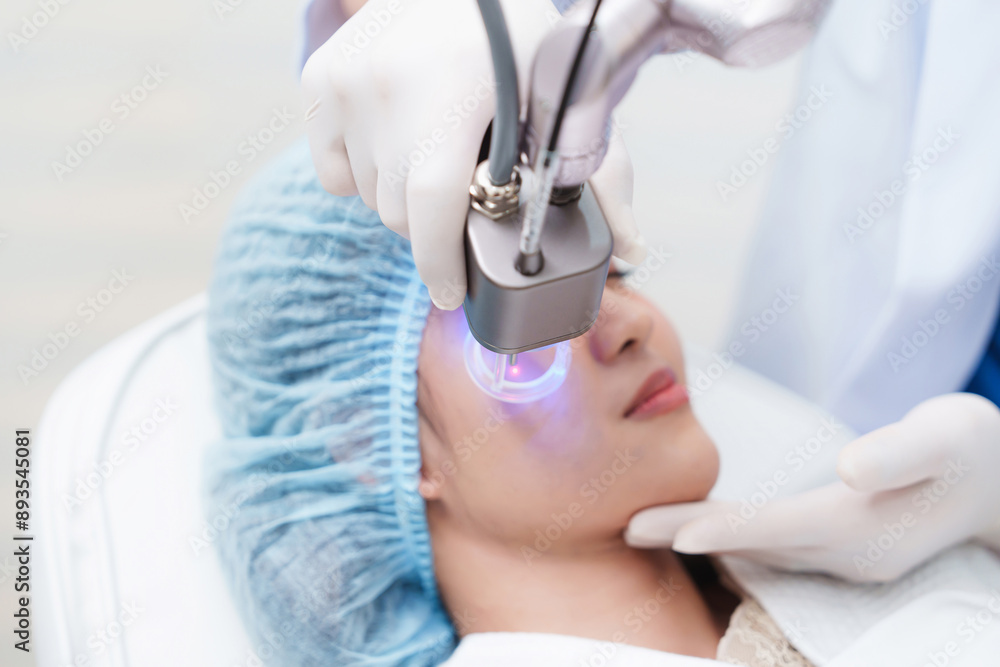 Side view of Asian woman getting resurfacing laser fraxel dual and ...
