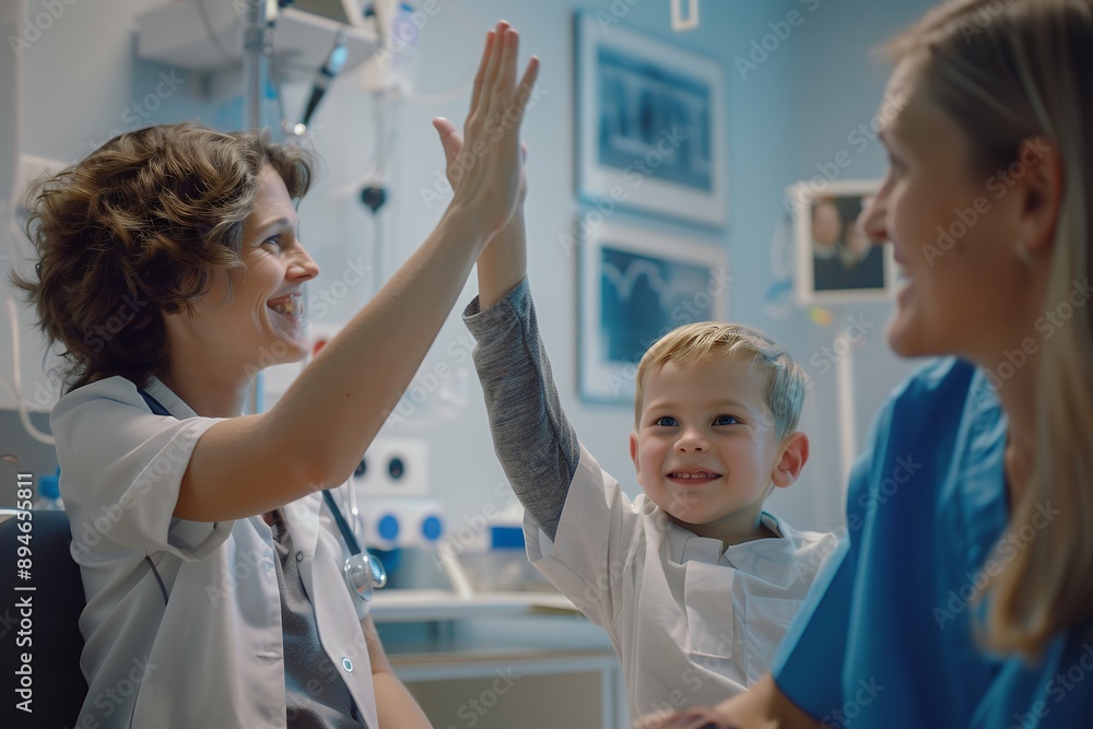 C nice doctor giving high five to child patient and mother in clinic ...