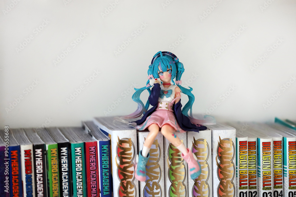 Stock-Foto „ Hatsune Miku figure sitting in a bookcase on manga books ...
