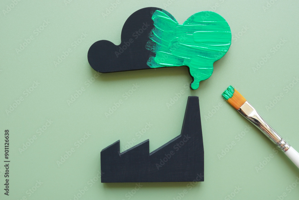 Sustainable manufacturing concept. Factory model, brush and green paint ...
