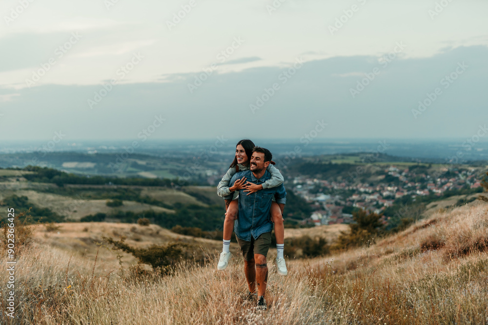 Couple having a piggyback ride, happy and smile hug in nature on a ...