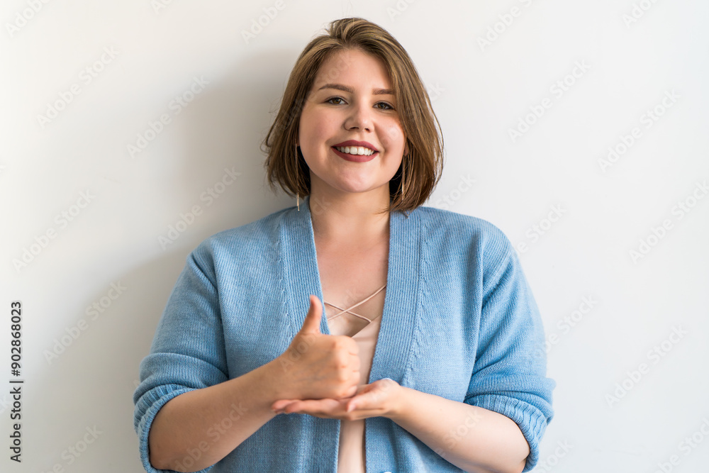 Plus size woman showing thumbs up sign in sign language, expressing ...