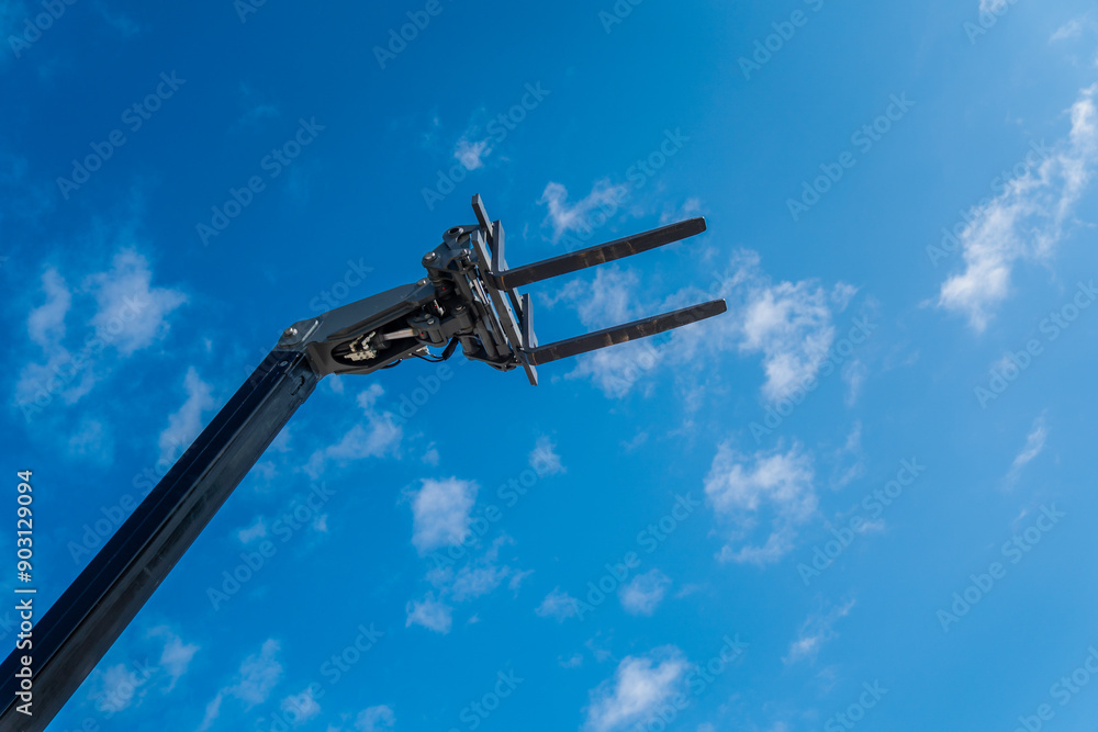 Telescopic lift with forklift raised up in the air for lifting ...