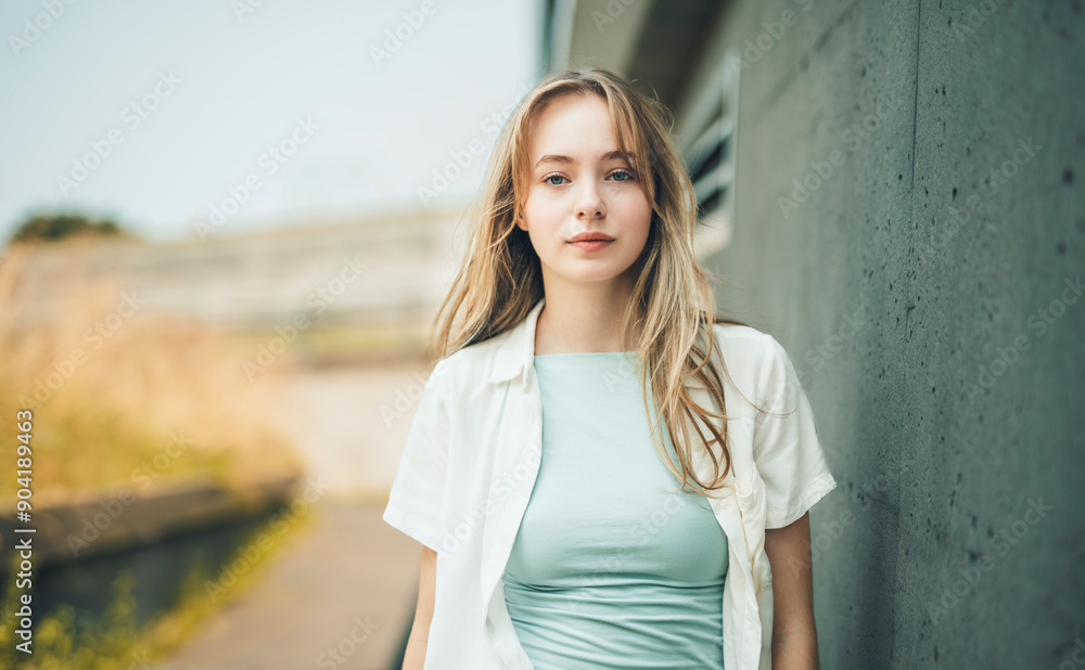 young woman on street, generation z girl posing outdoor backlit with ...