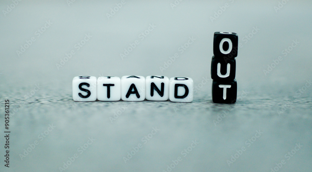 "Stand out" slogan written in colorful bead blocks. Self-esteem ...