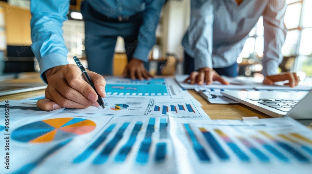 Business professionals reviewing a detailed roadmap for company growth ...