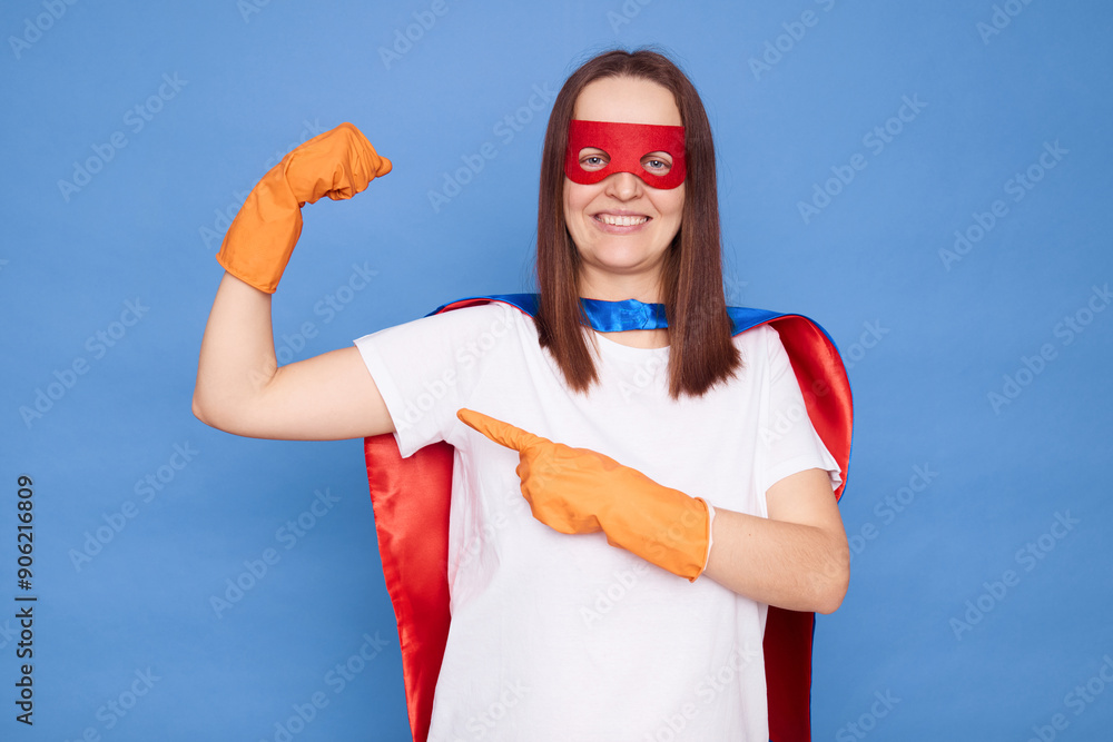 Superhero adult woman raising arm showing pointing biceps ready to save ...