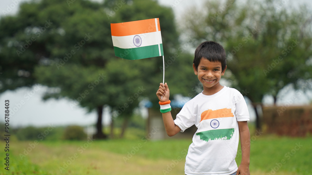 Cute Little Indian village boy proudly holds the tricolour Indian flag ...