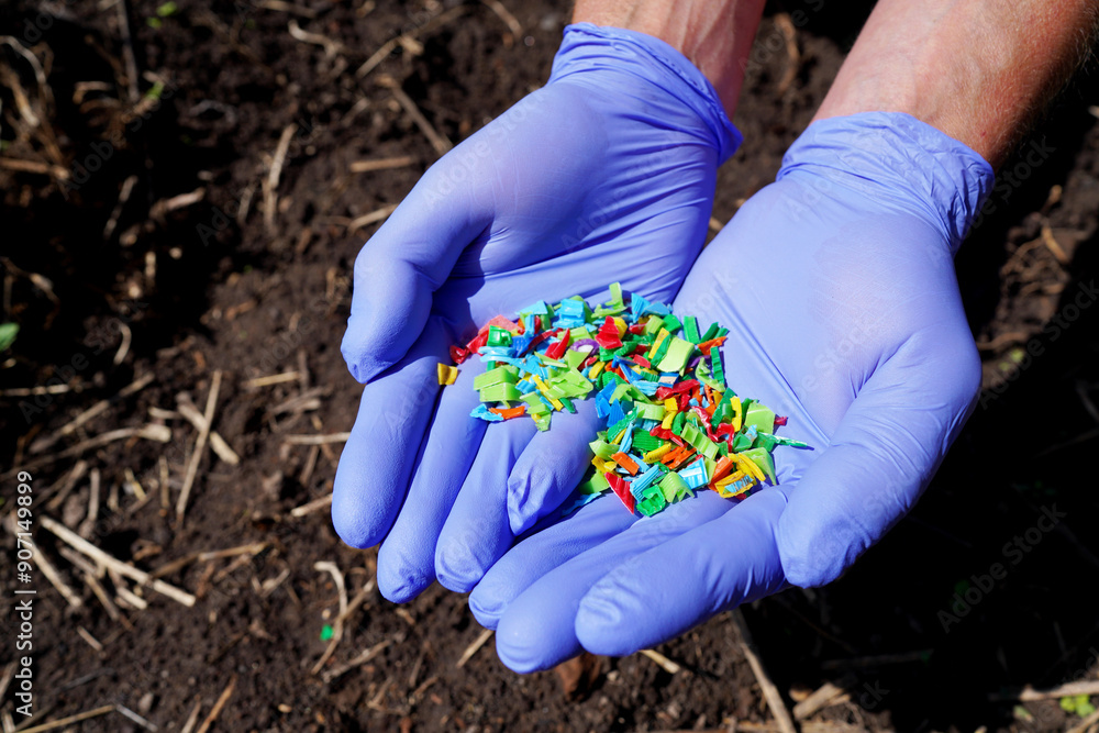 Microplastic pollution. Microplastics in ground. Soil contaminated with ...