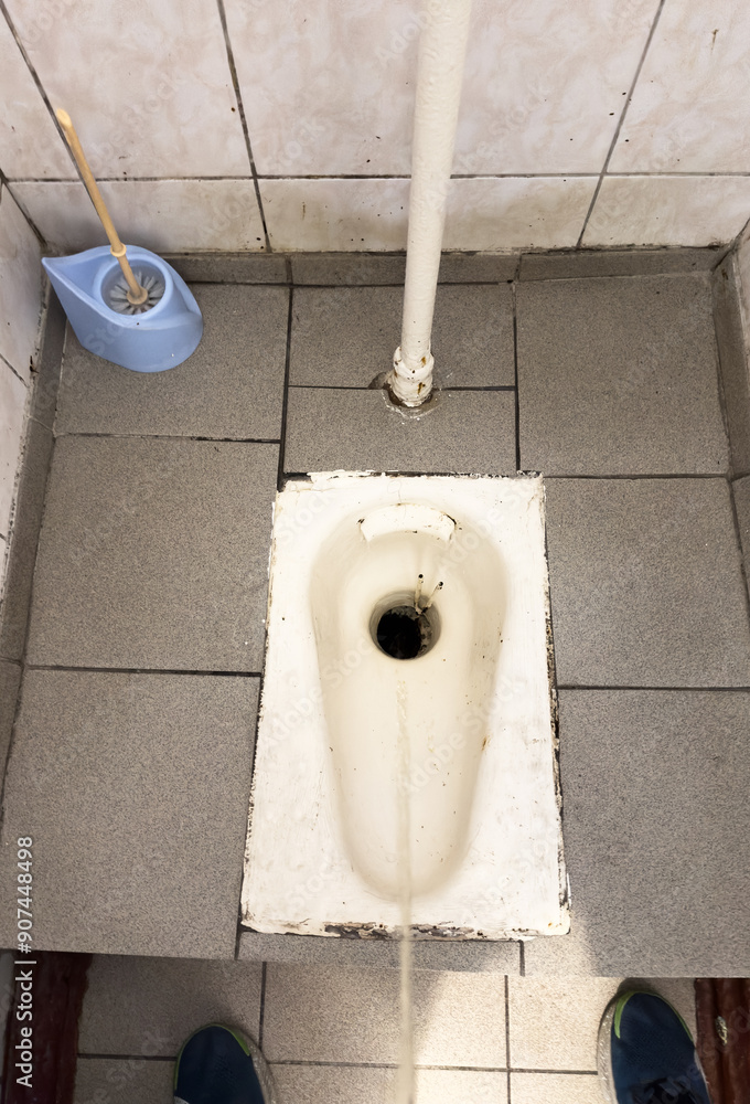 Photo Stock Man urinating. Tream of urine drops from height in toilet ...